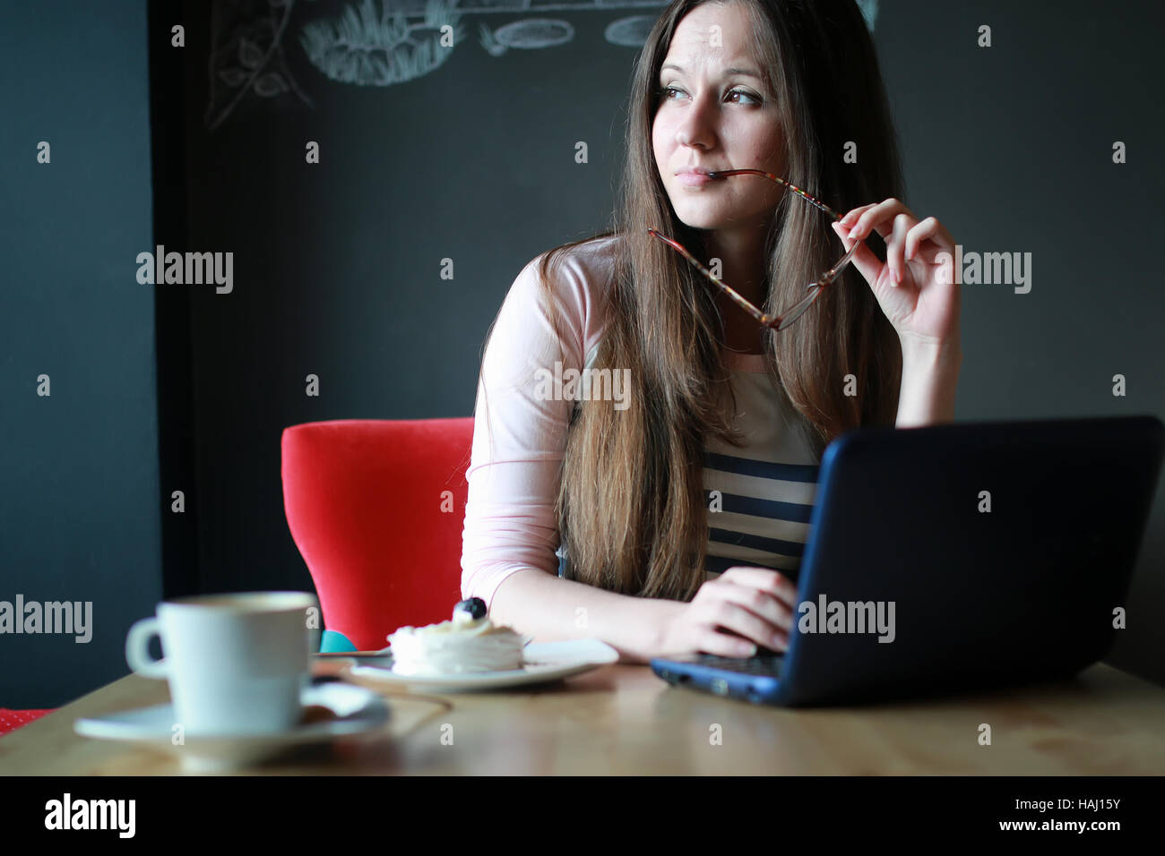 girl in a cafe for a cup of coffee with the notebook Stock Photo - Alamy