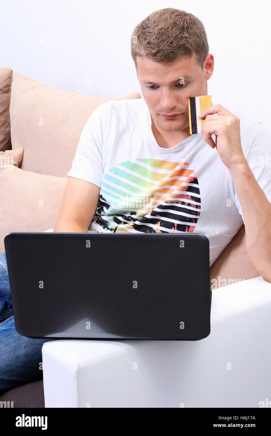 man shopping online using credit card and laptop Stock Photo - Alamy