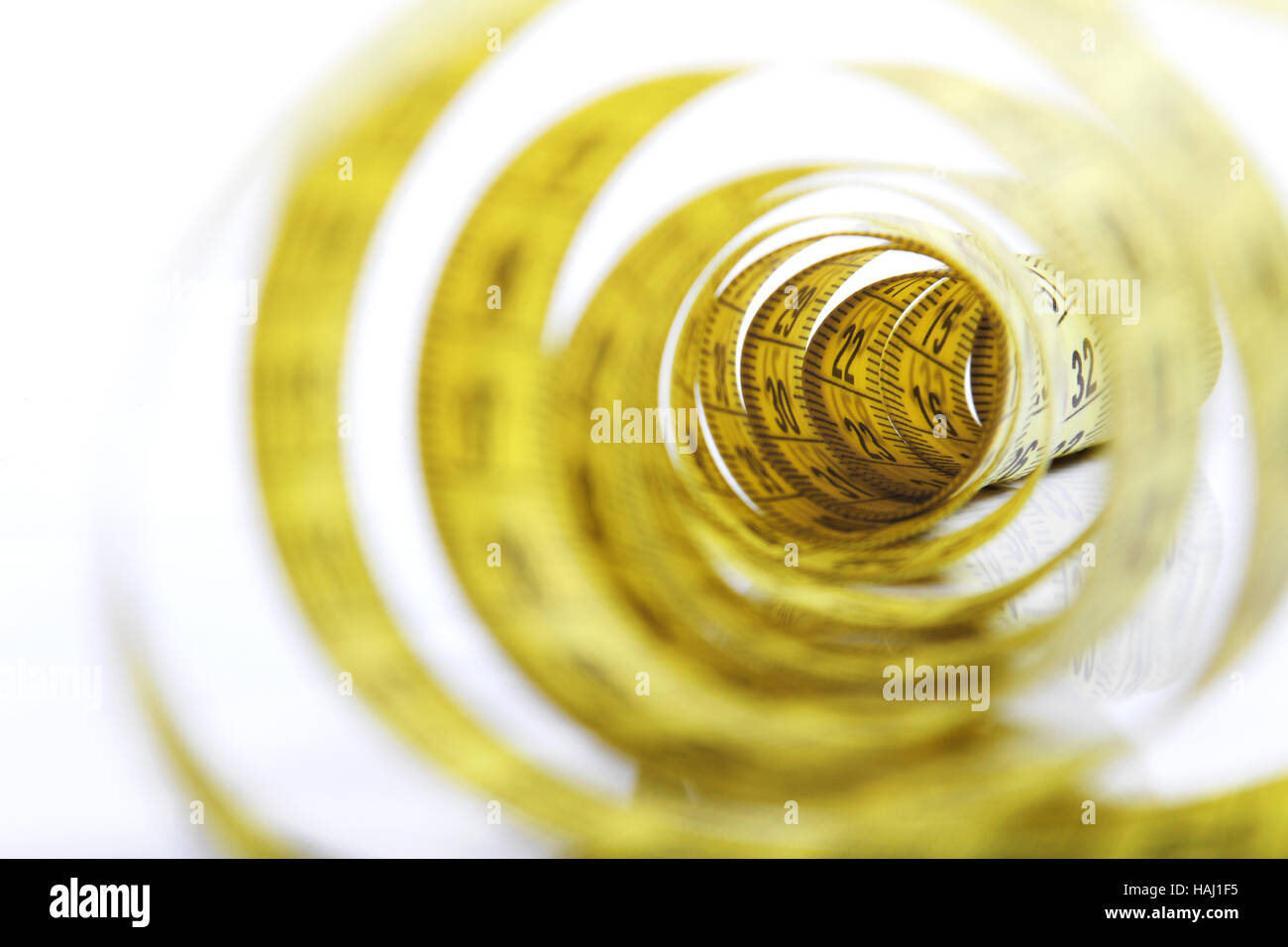 yellow measuring tape swirl Stock Photo - Alamy