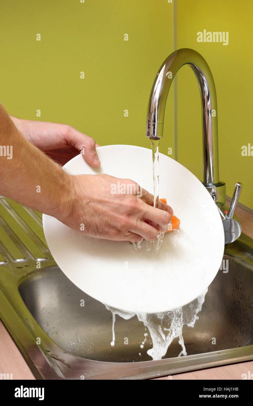 washing dishes in the kitchen Stock Photo - Alamy