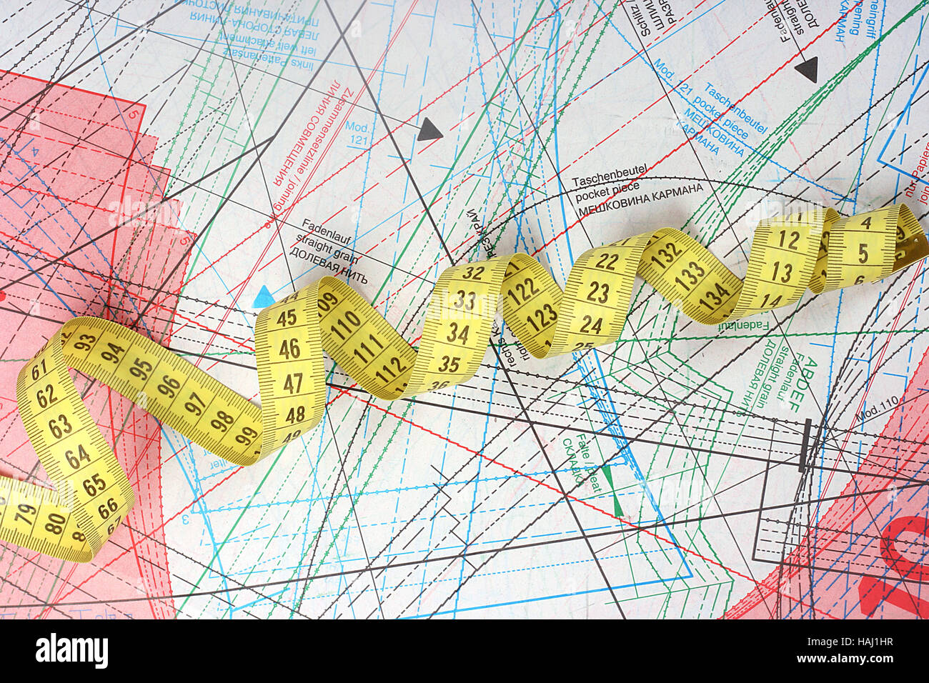 yellow tailor measuring tape on patterns of clothing Stock Photo - Alamy