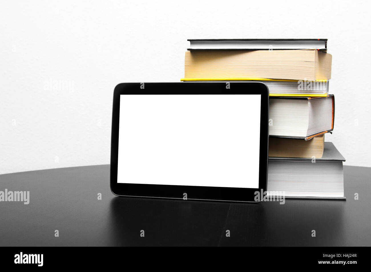 blank digital tablet and stack of books Stock Photo - Alamy