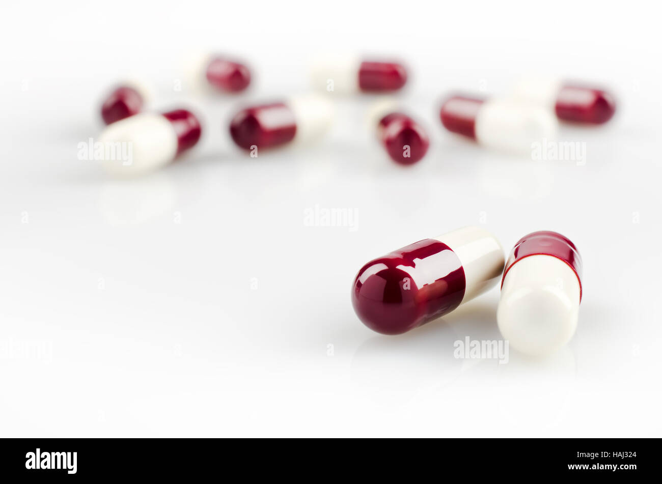 Medical theme. Dark red capsules on a white surface. Closeup Stock ...