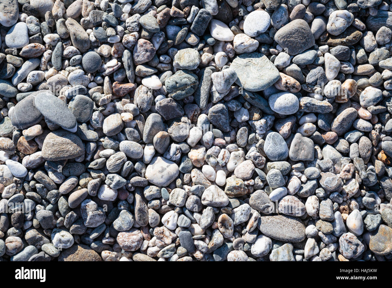 Pebbles on a beach in Sicily Stock Photo - Alamy