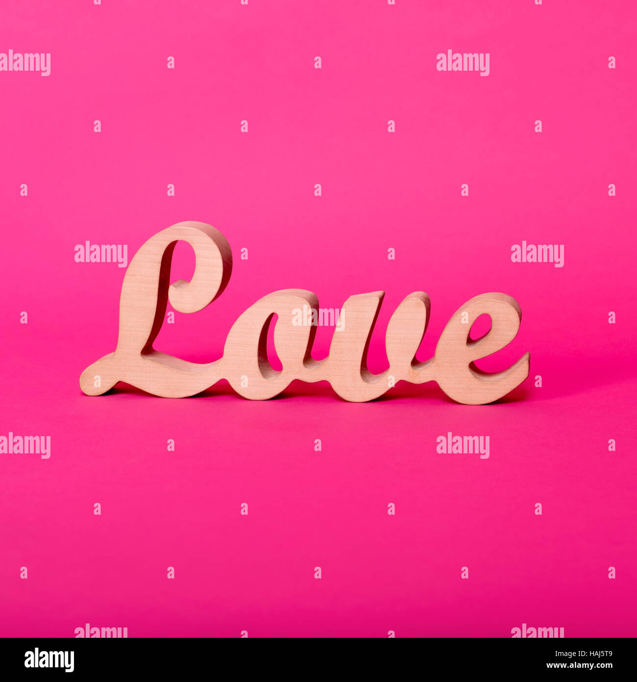 Word love, wooden letters on pink paper. Valentine's day background ...