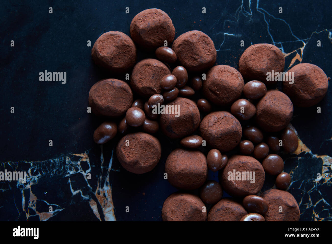 Homemade chocolate truffles on a black marble background Stock Photo ...