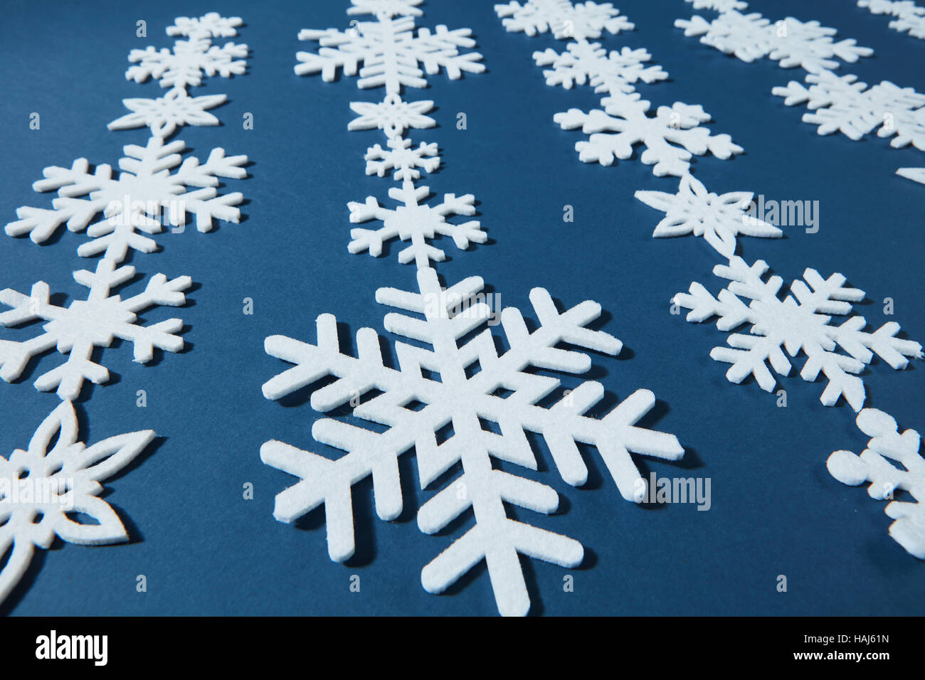Snowflakes of different sizes in a row on a blue background Stock Photo ...