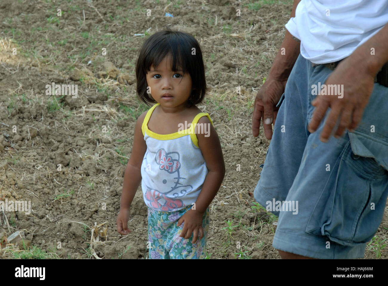 A farmer with his daughter in his rice paddy fields, Lawigan, San ...