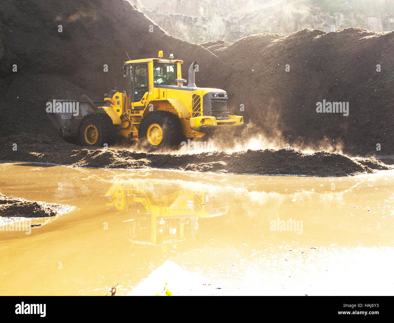 A Loader shovel moving Mulch Stock Photo - Alamy