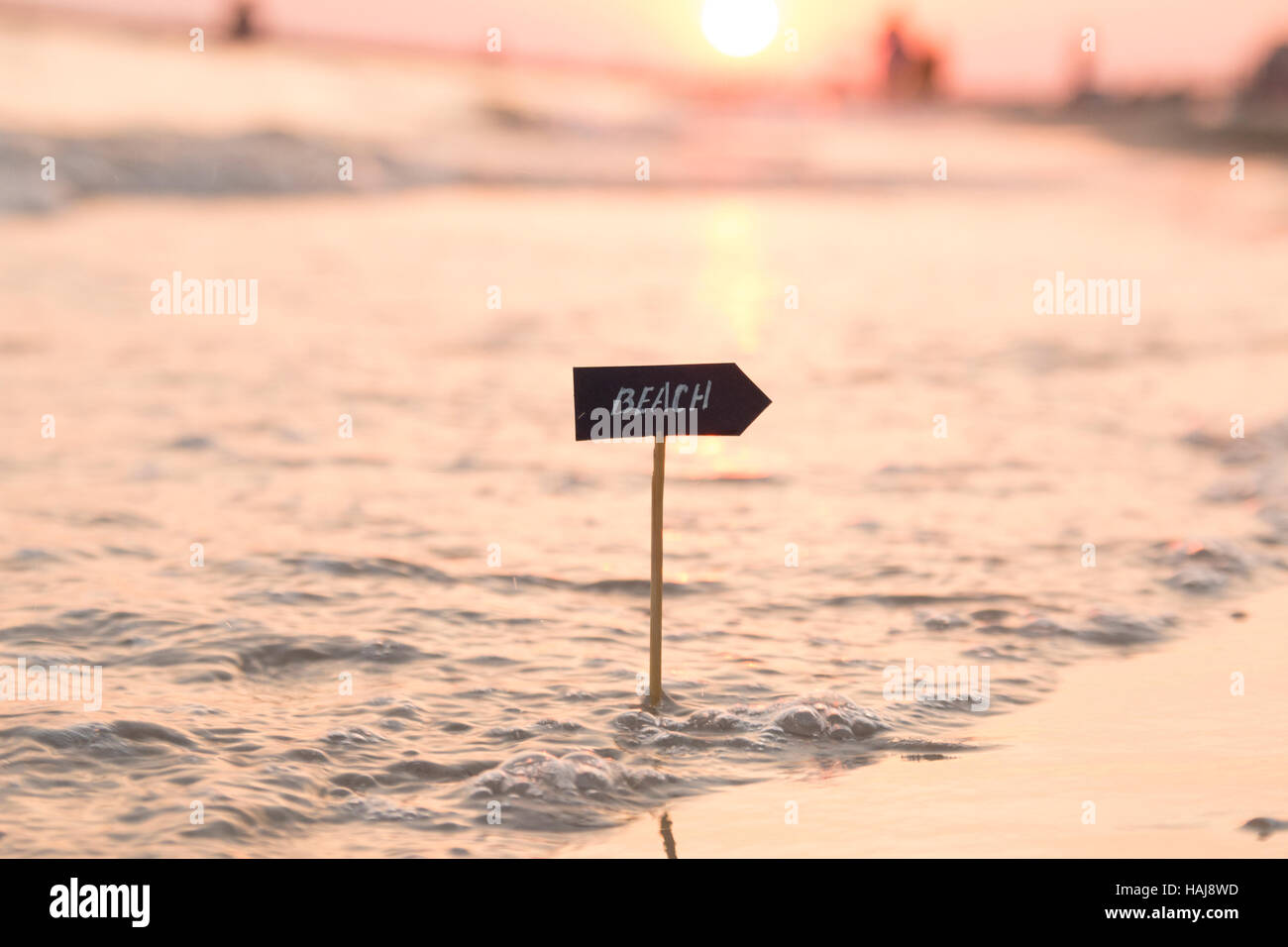 Vacation holidays idea - beach sign and sunset Stock Photo - Alamy
