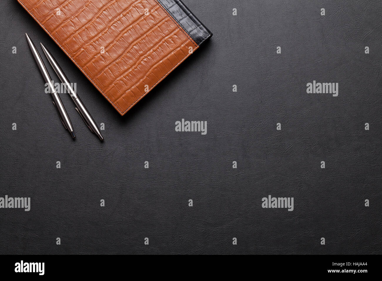 Office leather desk table with notepad, pen and pencil. Top view with ...