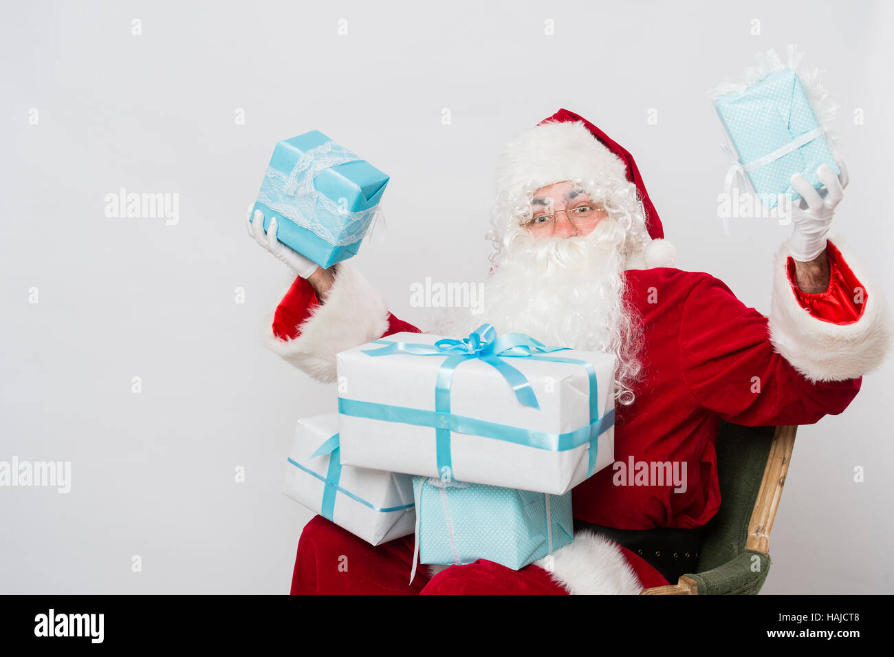 Santa Claus holding pile of gift boxes Closeup Portrait Stock Photo - Alamy
