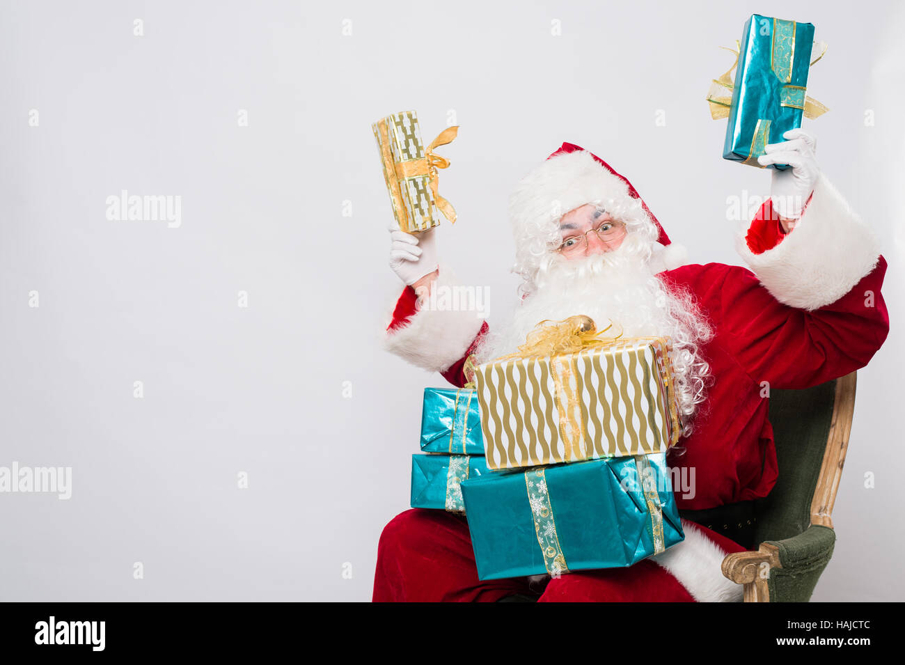 Santa holding many christmas gifts hi-res stock photography and images ...