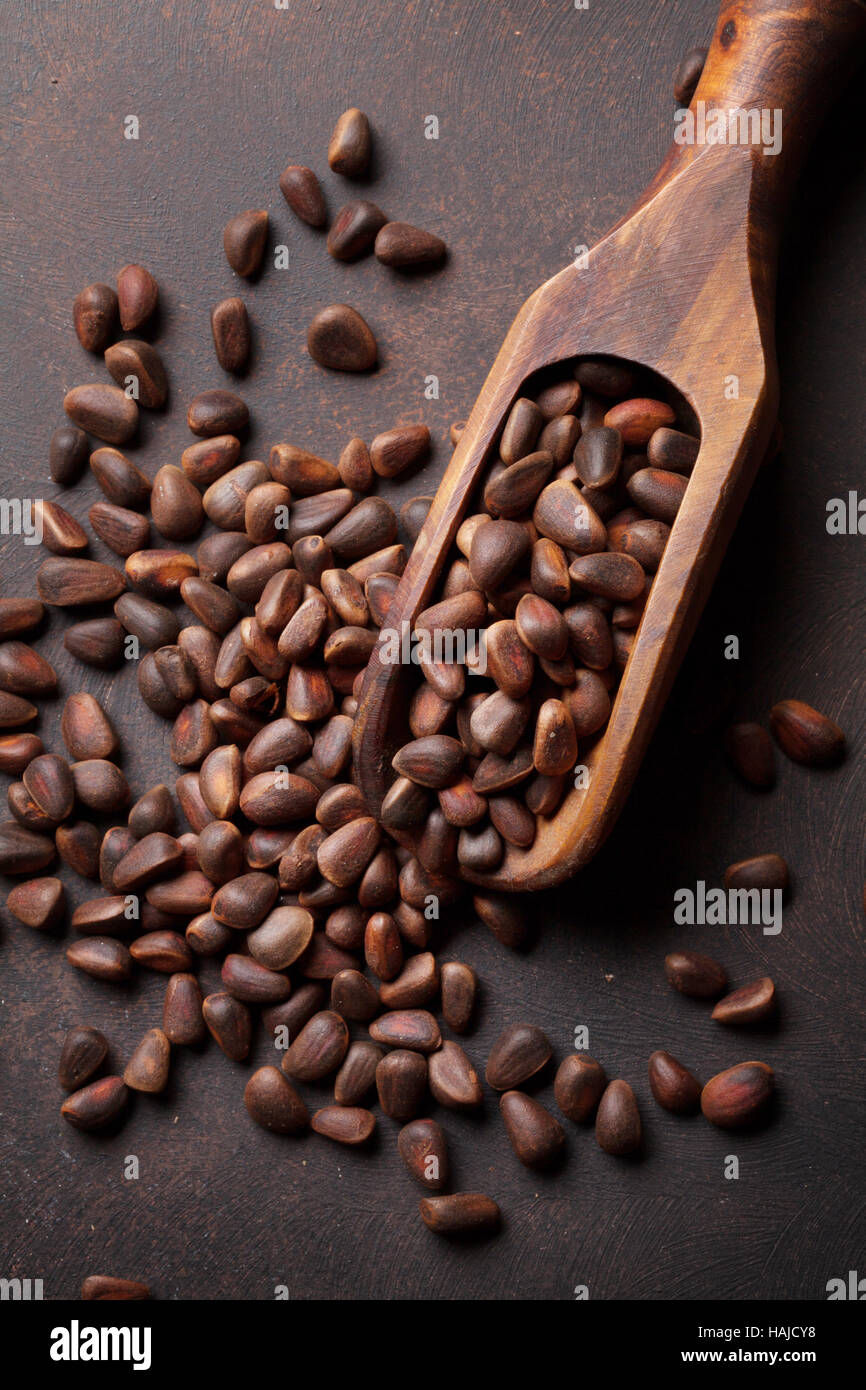 Pine nuts on stone table. Top view Stock Photo - Alamy