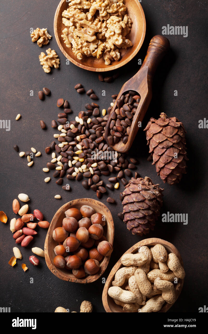 Various nuts on stone table. Top view Stock Photo - Alamy