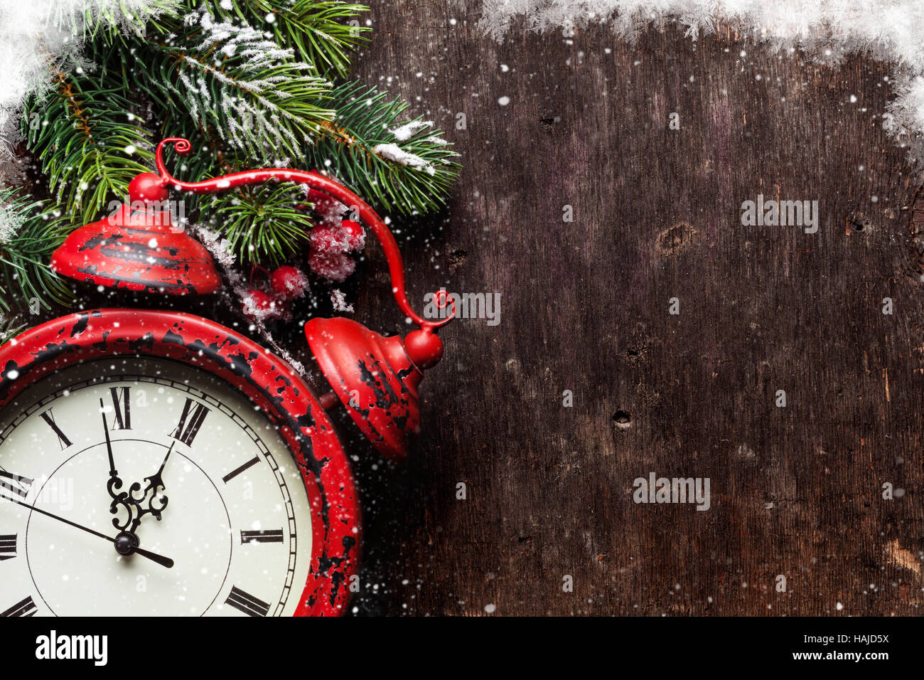 Christmas fir tree and alarm clock over old wooden texture background ...