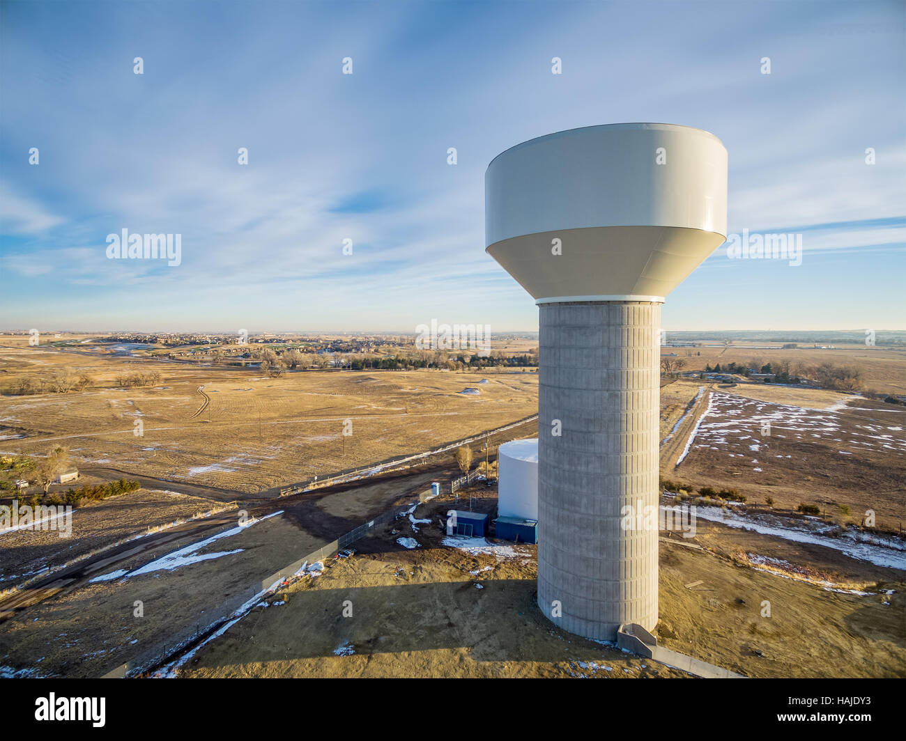 aerial view of a water tower near a new house development along ...
