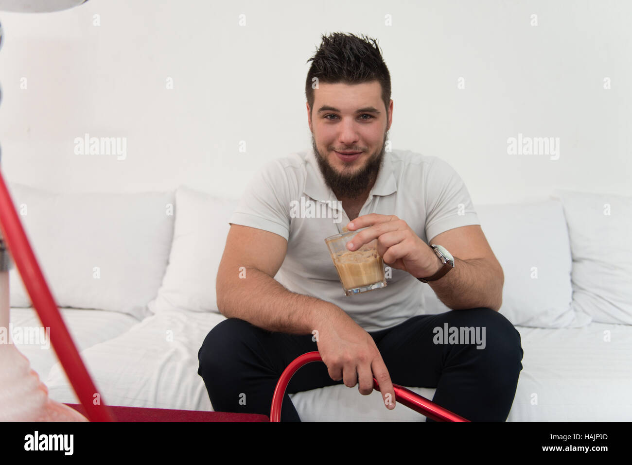 Young Man Smoking Shisha At Arabic Restaurant Man Exhaling Smoke