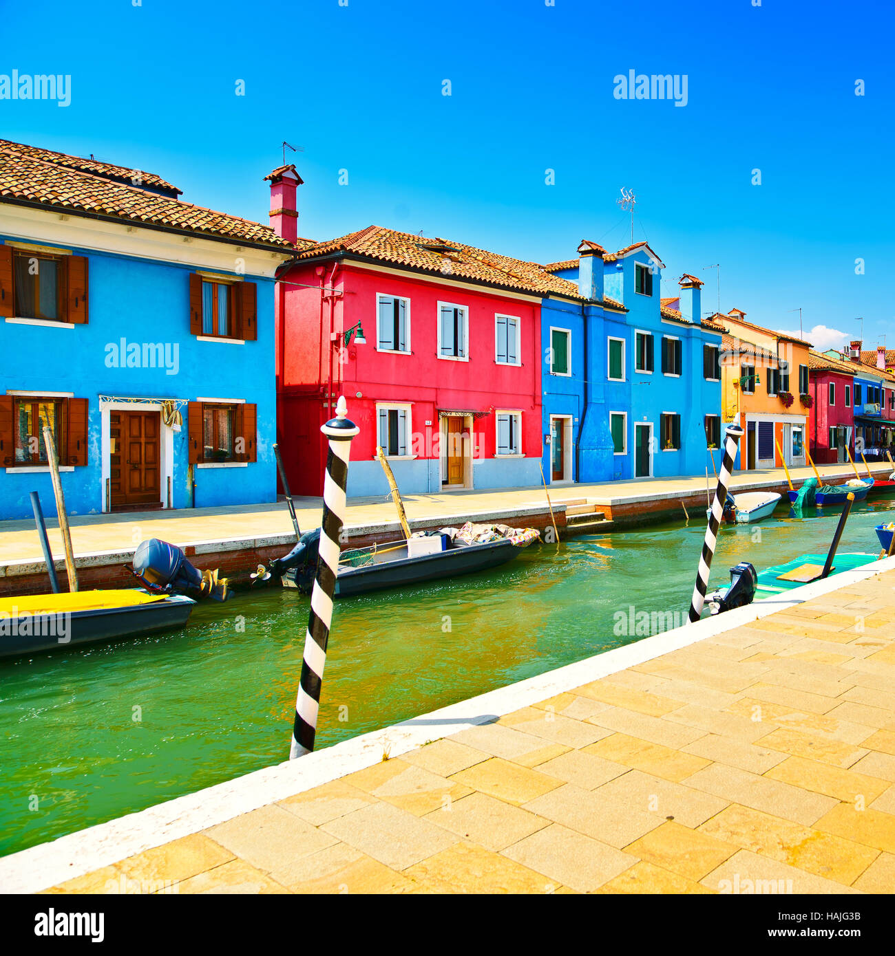 Venice landmark, Burano island canal, colorful houses and boats, Italy ...