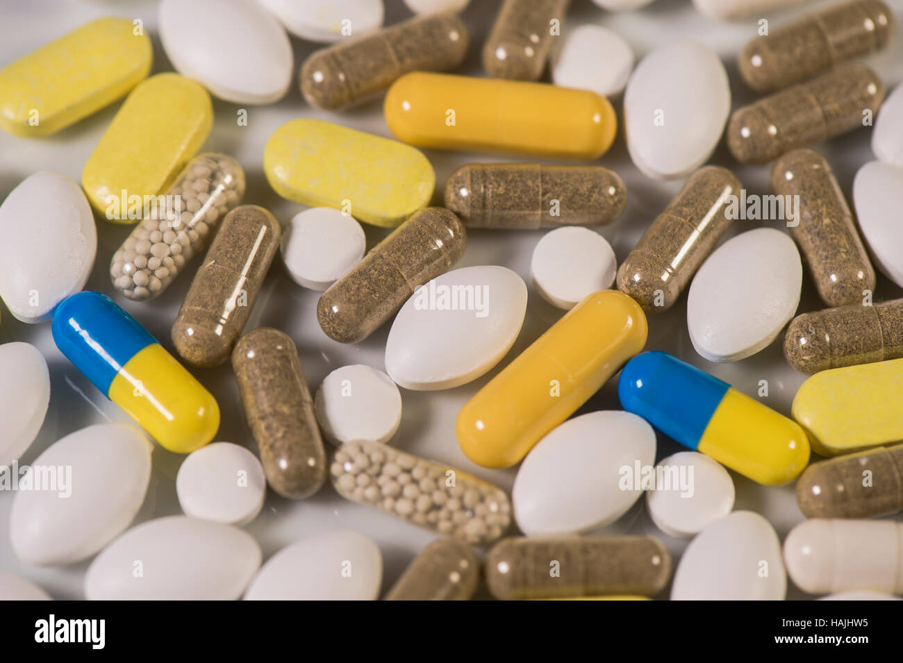 Colored pills, tablets and capsules on a white background Stock Photo ...