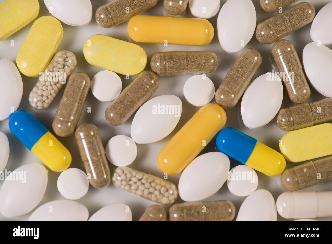 Colored pills, tablets and capsules on a white background Stock Photo ...