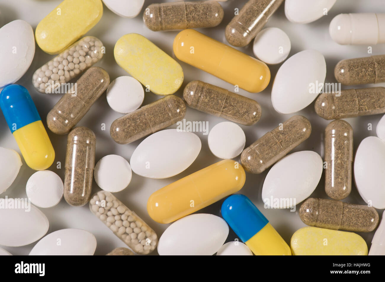 Colored pills, tablets and capsules on a white background Stock Photo ...