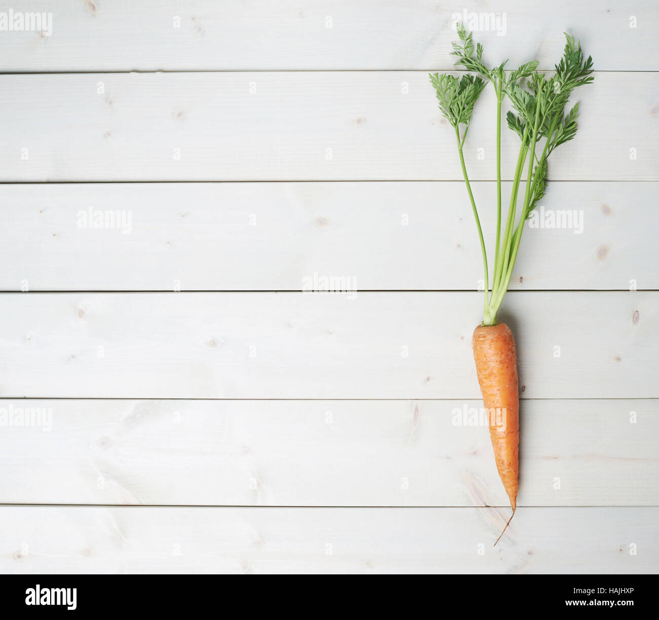 Raw whole carrot on wooden surface table Stock Photo - Alamy
