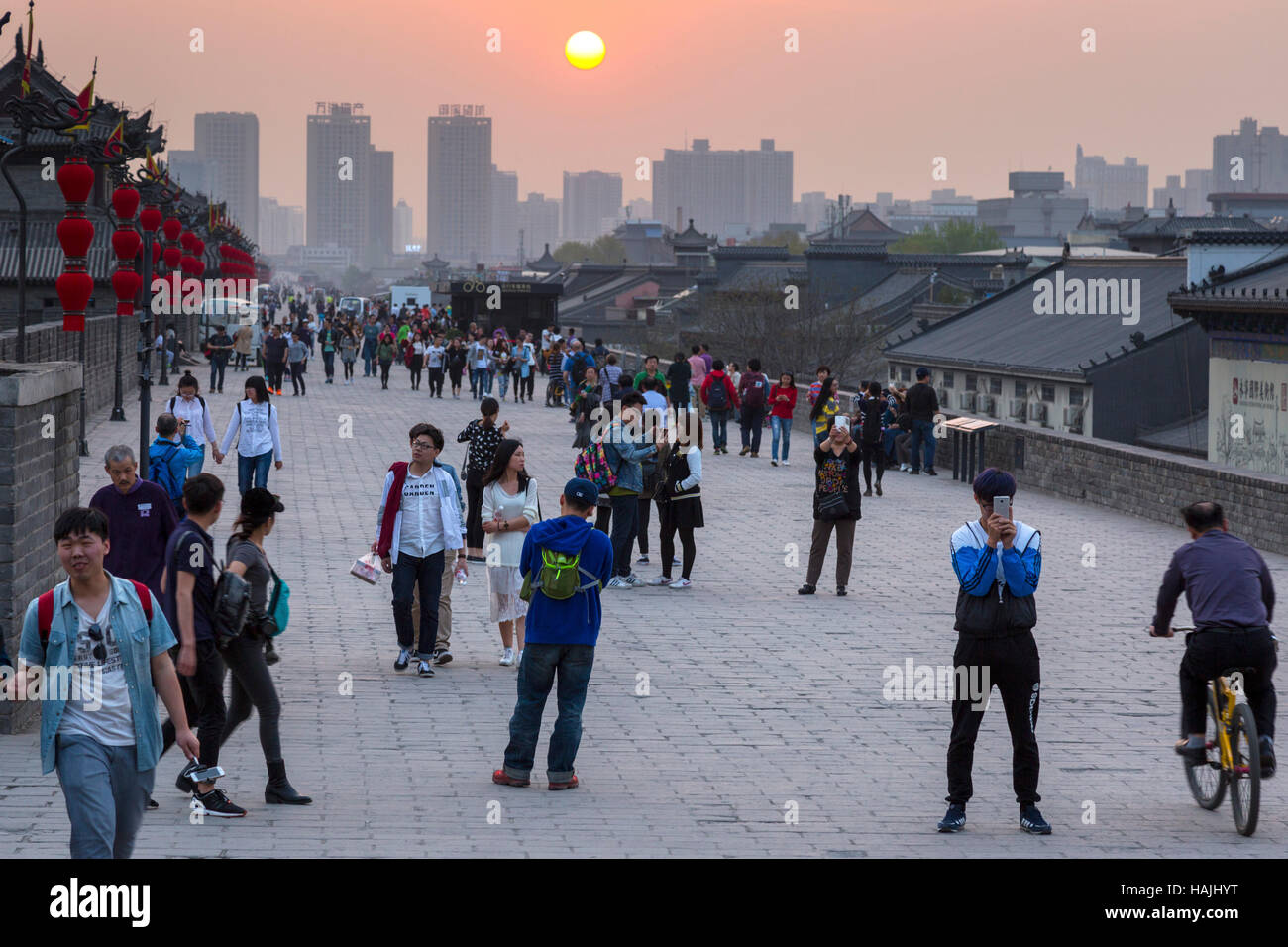Tourists walking on Xian city walls at sunset, Shaanxi, China Stock ...