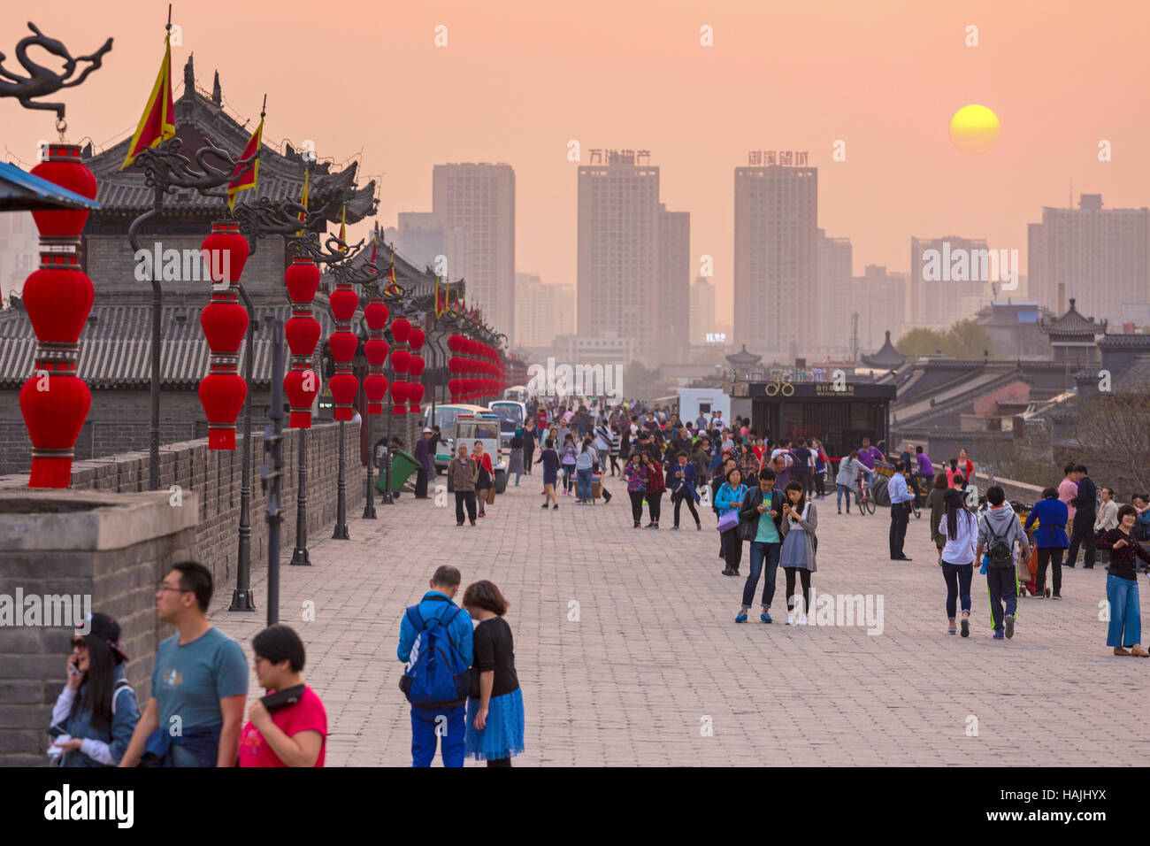 Tourists walking on Xian city walls at sunset, Shaanxi, China Stock ...