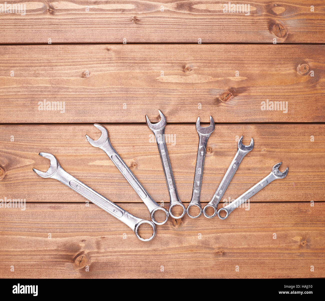 Set of wrenchs chrome metal spanner instruments on wooden surface Stock ...