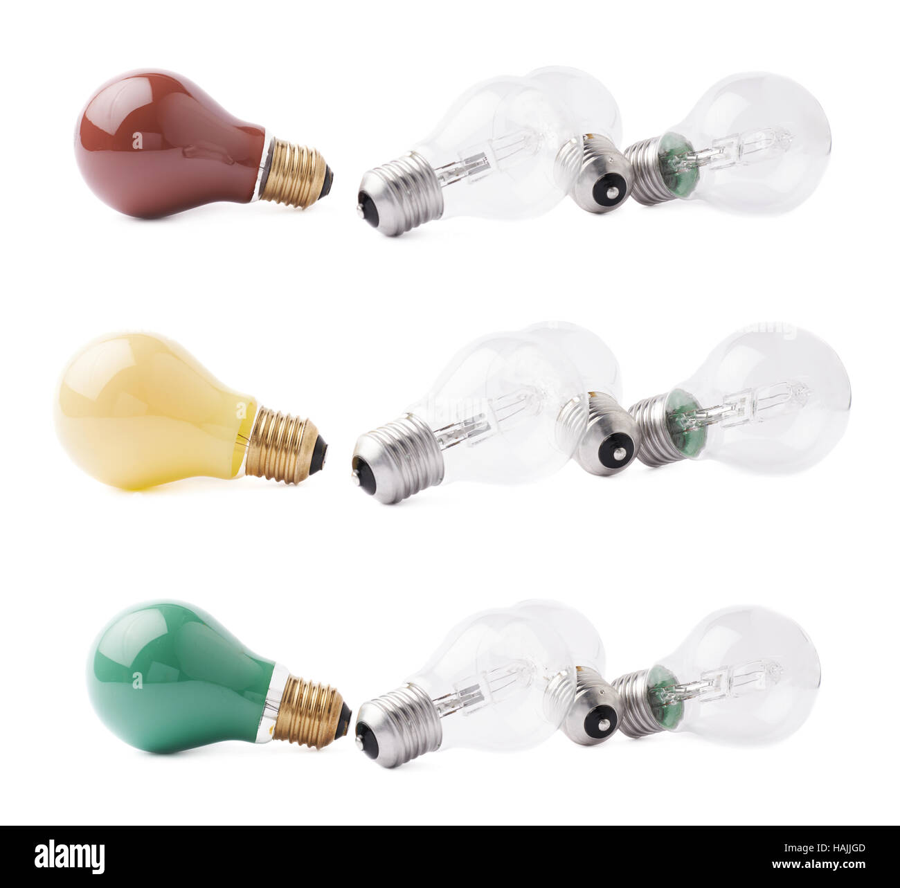 Colored bulbs lying next to couple of transparent bulbs over white ...