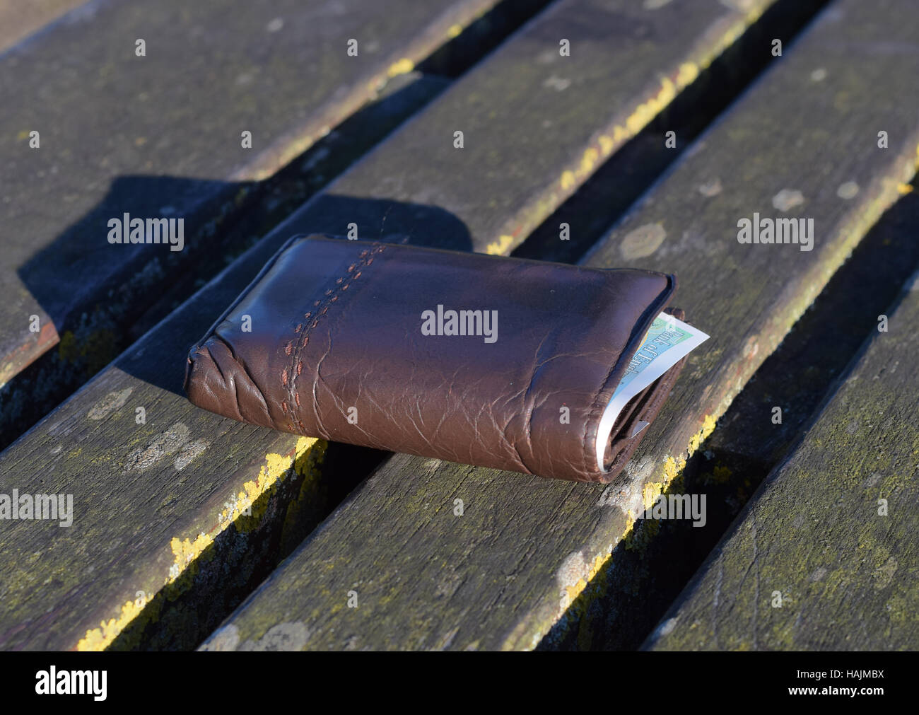 The lost wallet with cash on a park bench Stock Photo - Alamy