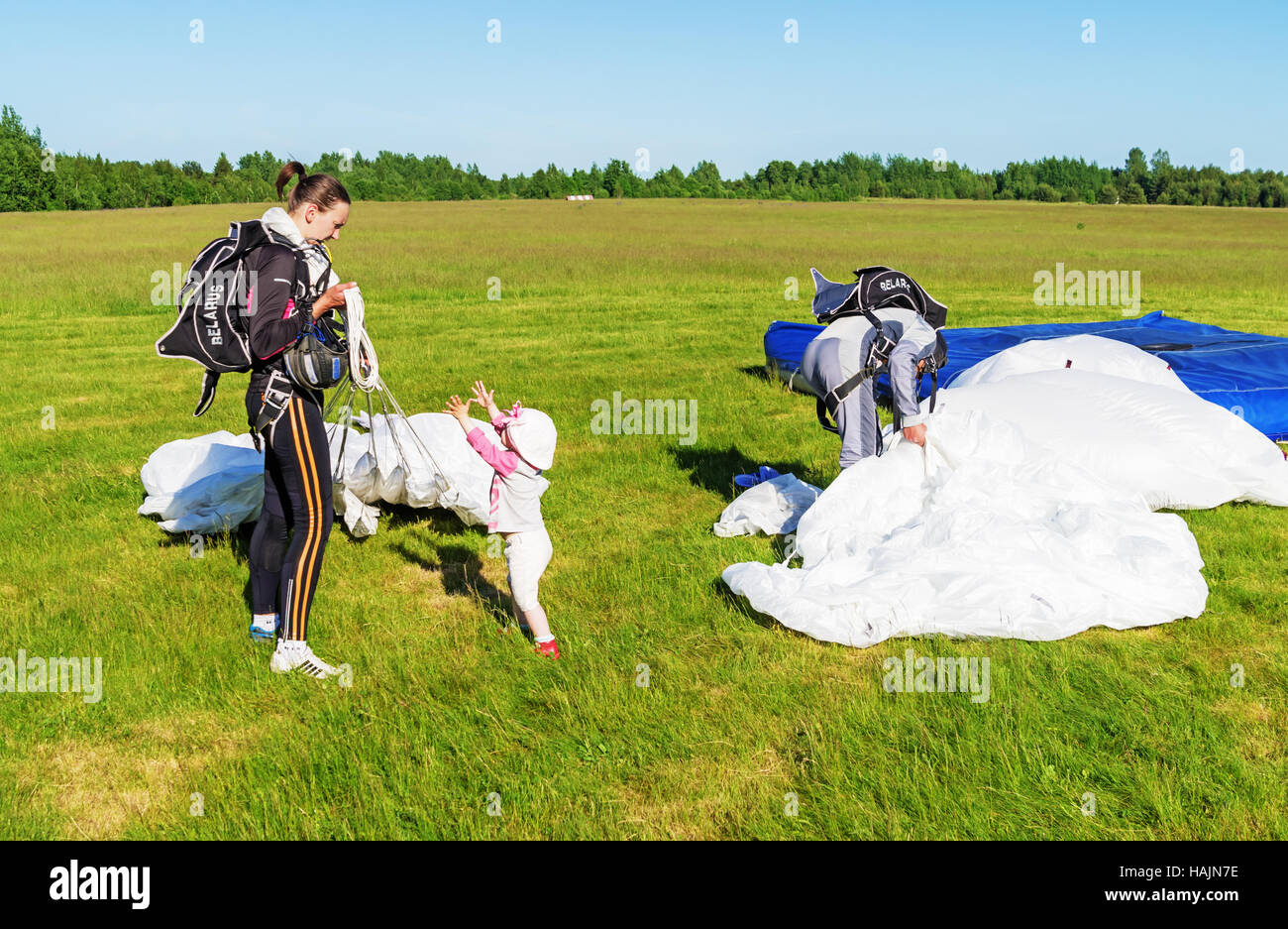 Parachutists - 2015.After landing.Skydivers and their child Stock Photo ...
