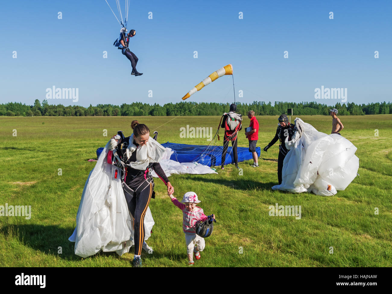 Parachutists - 2015.After landing.Skydivers and their child Stock Photo ...
