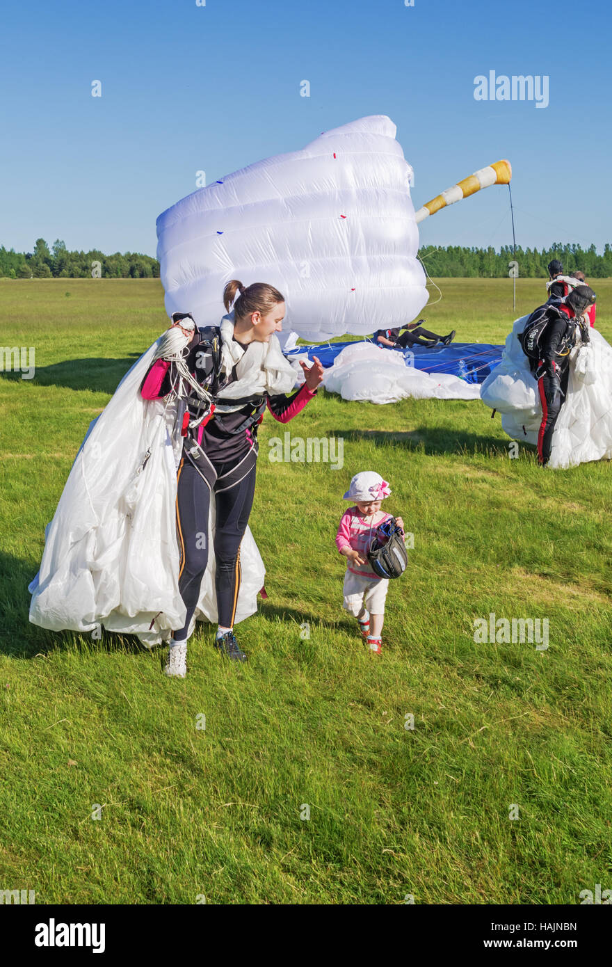Parachutists - 2015.After landing.Skydivers and their child Stock Photo ...