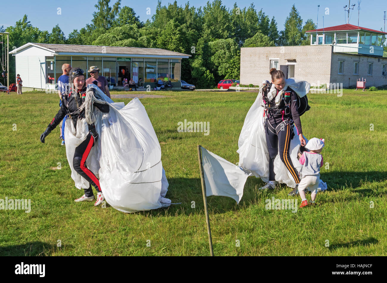 Parachutists - 2015.After landing.Skydivers and their child Stock Photo ...