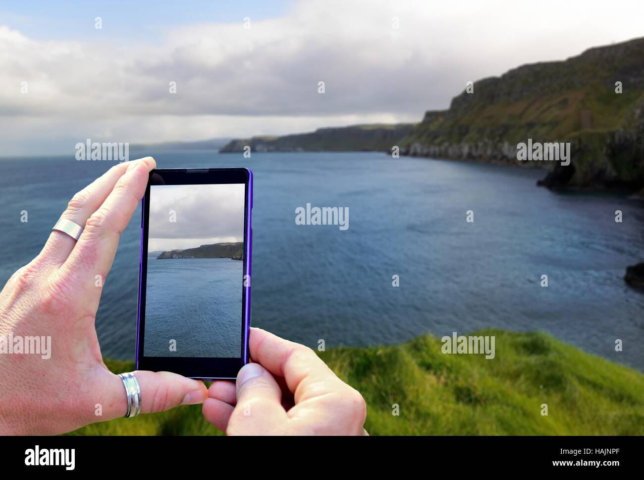 View over the mobile phone display during taking a picture of coast and ...