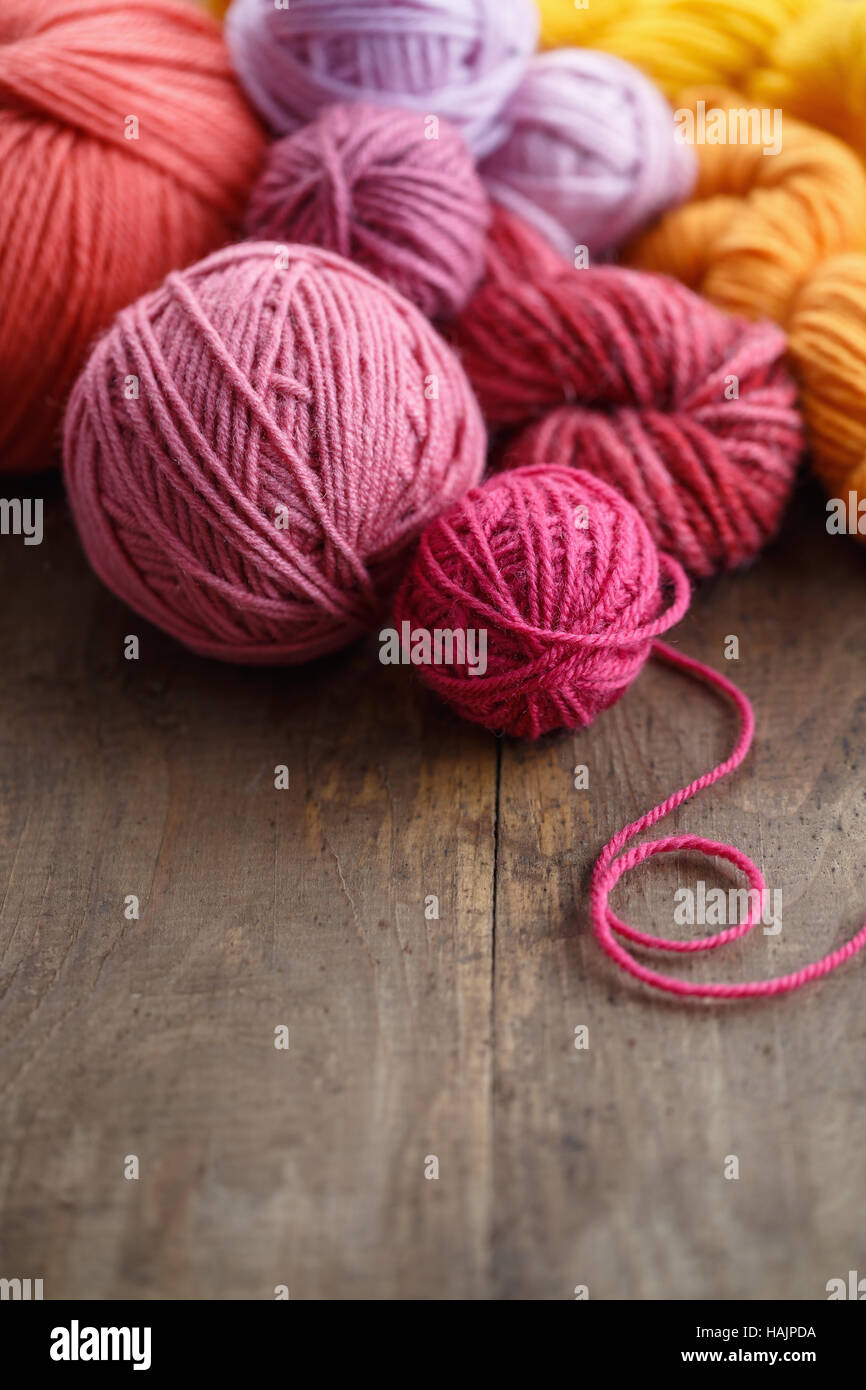 Balls of wool on old wooden background Stock Photo - Alamy