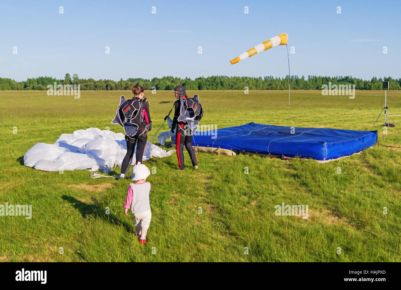 Parachutists - 2015.After landing.Skydivers and their child Stock Photo ...