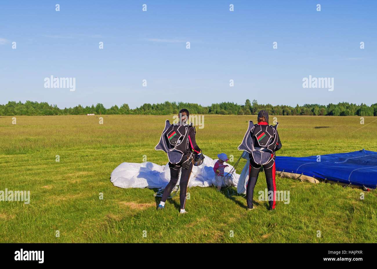Parachutists - 2015.After landing.Skydivers and their child Stock Photo ...