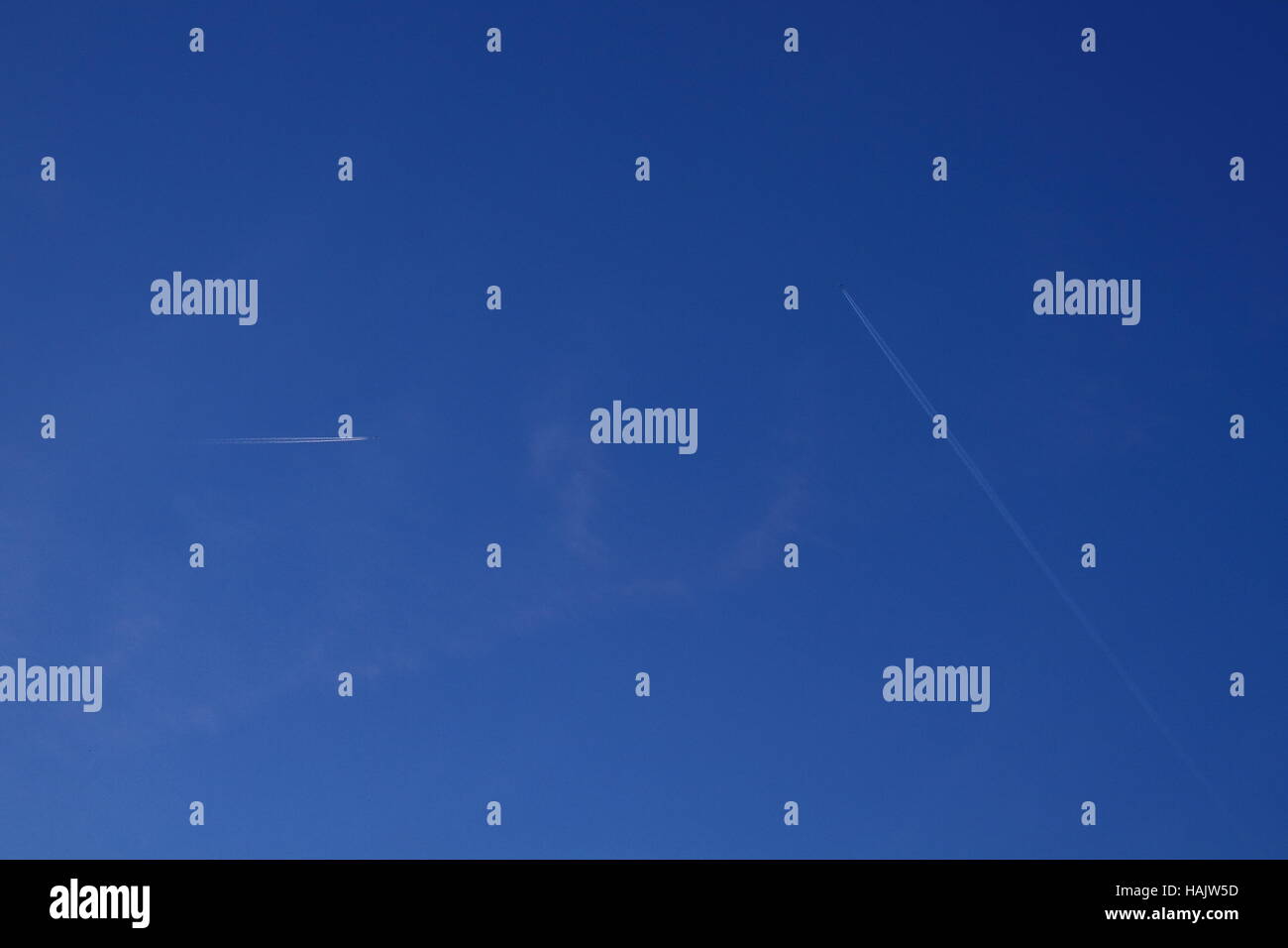 Airline jet streams isolated in a blue sky image with copy space Stock ...