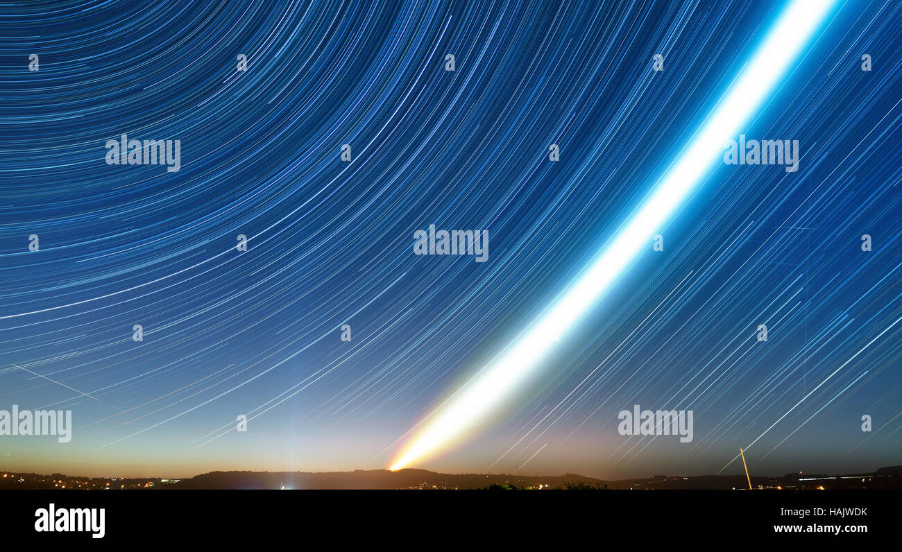 star trails on blue night sky Stock Photo - Alamy