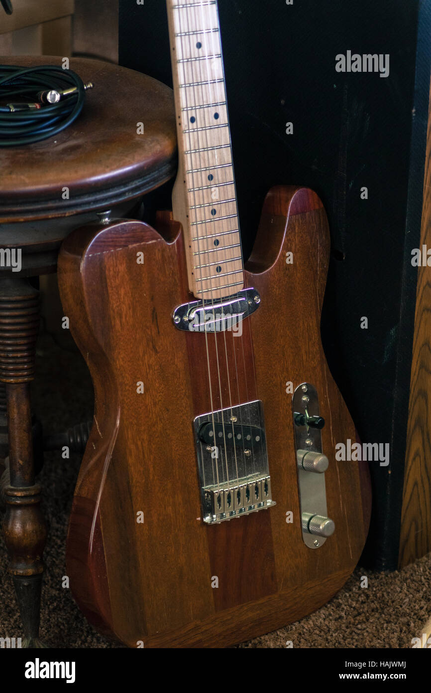 A funky Telecaster style guitar made of different species of wood glued ...