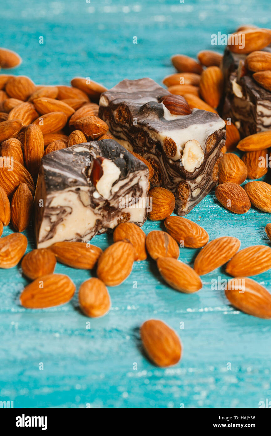 candy paste and almonds on blue wooden background Stock Photo - Alamy