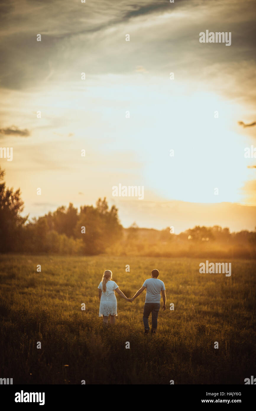 love story man and woman on the background of haystacks and sun Stock ...