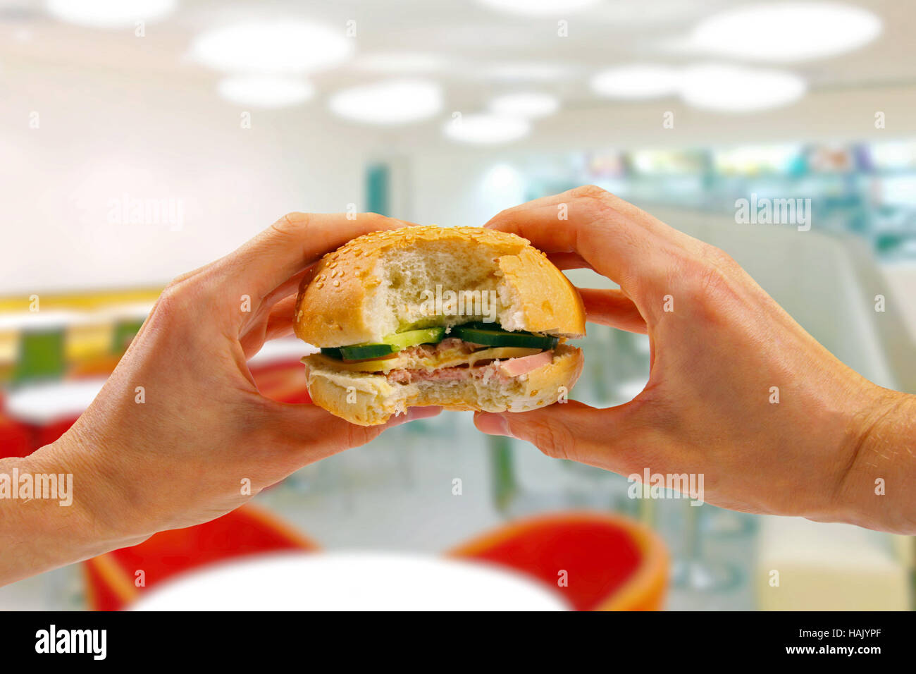 hands hold a burger in fast food restaurant Stock Photo - Alamy