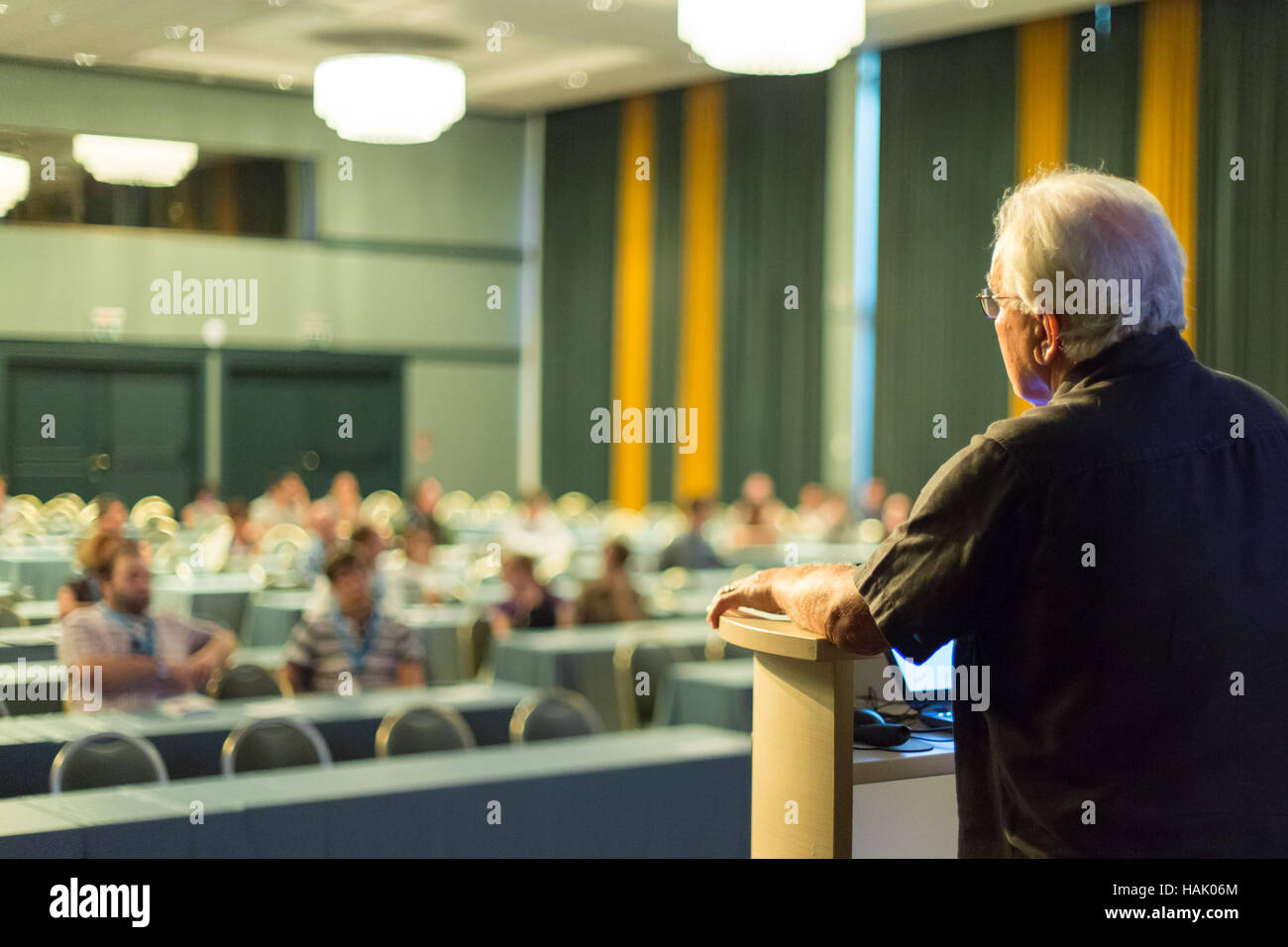 Senior public speaker giving talk at scientific conference Stock Photo ...