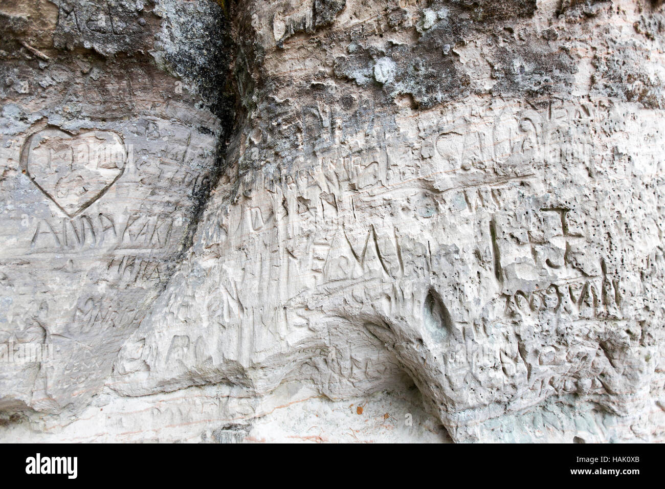 sandstone cliff wall with inscriptions Stock Photo - Alamy
