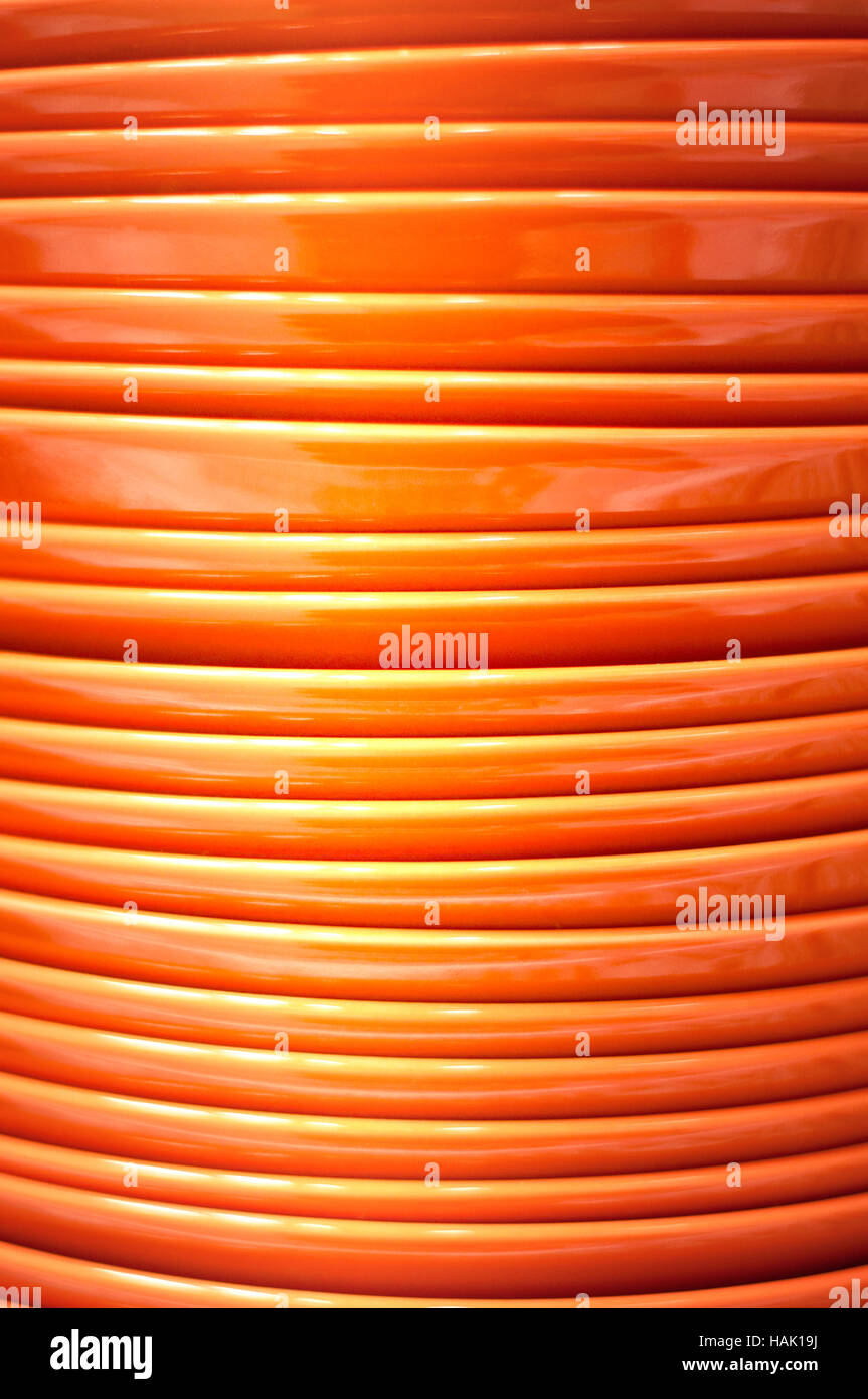 Stack of ceramic orange plates close-up Stock Photo - Alamy