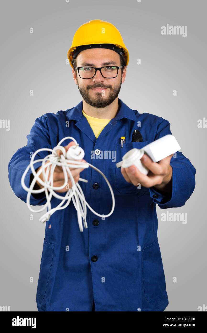 smiling electrician with tools isolated on gray background Stock Photo ...
